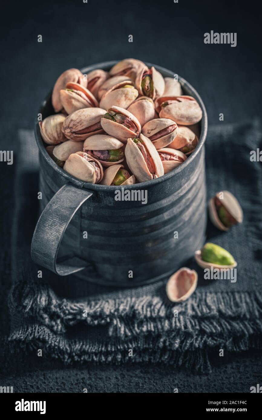 A pile of pistachios in a rustic metal box Stock Photo - Alamy
