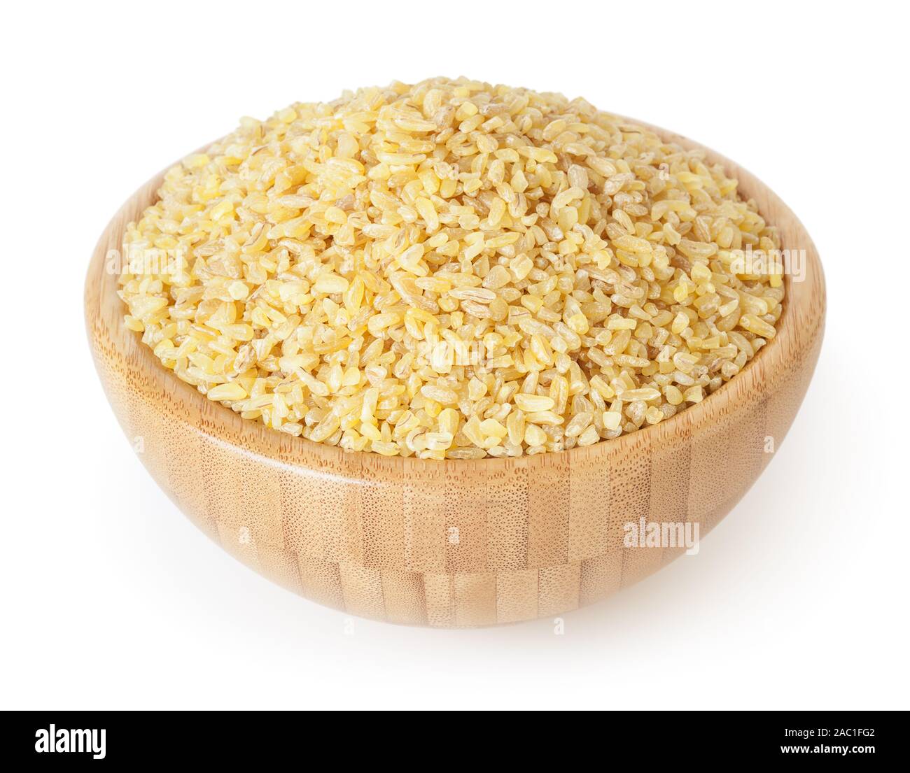 Uncooked bulgur in wooden bowl isolated on white background with ...