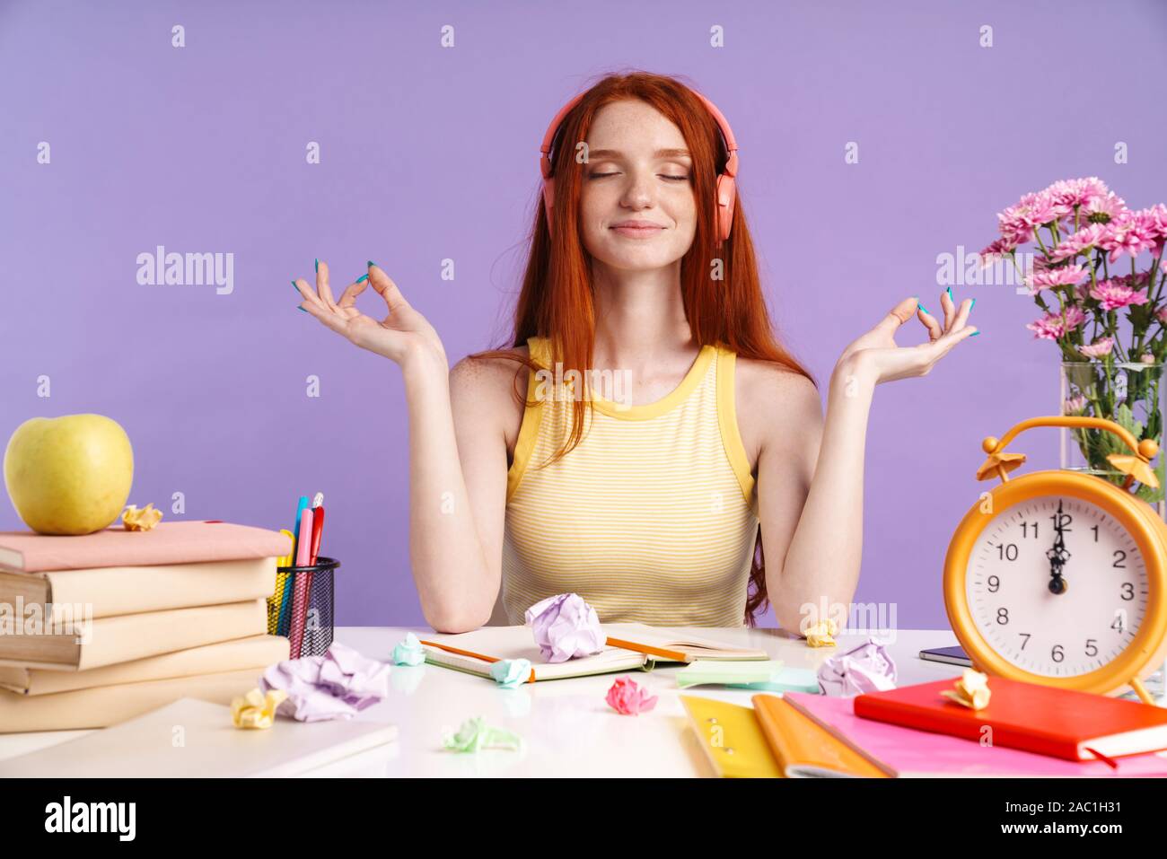 Photo of relaxed student girl in headphones sitting at desk with ...
