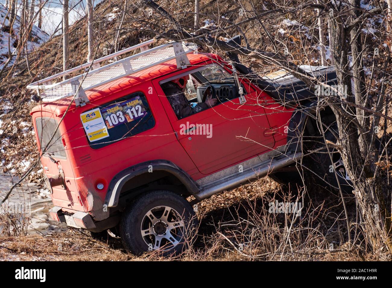 Jeep Suzuki Jimny overcomes obstacles in the forest Stock Photo - Alamy