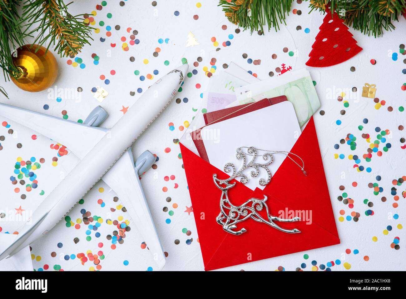 Photo of red envelope, cookies, plane, branches of spruce Christmas ...