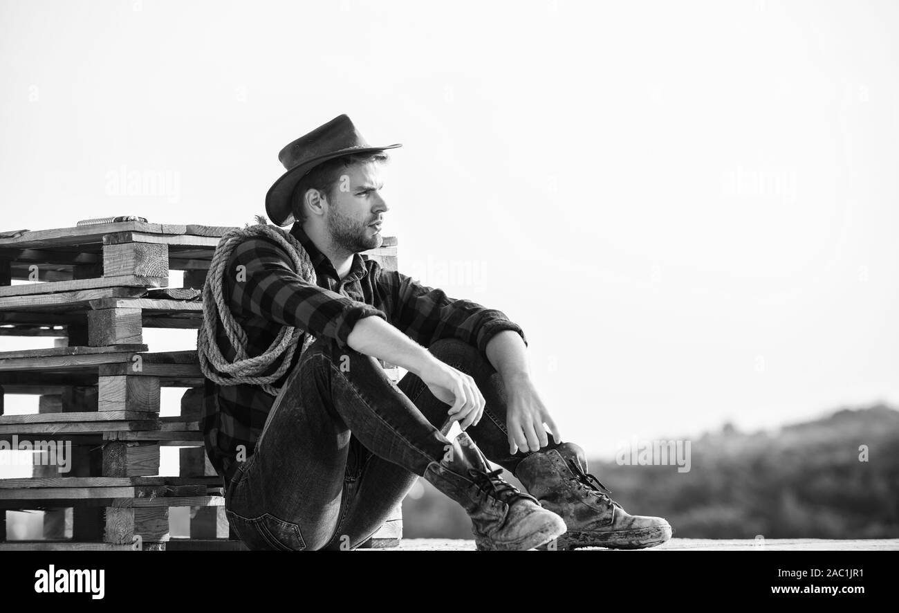 Watching sunset. Farmer cowboy handsome man relaxing after hard working ...