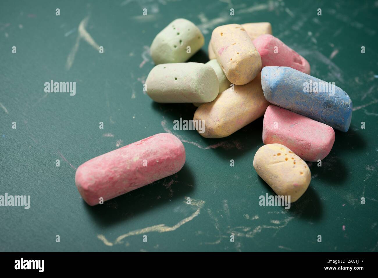 View of a group of chalks and a green blackboard Stock Photo - Alamy