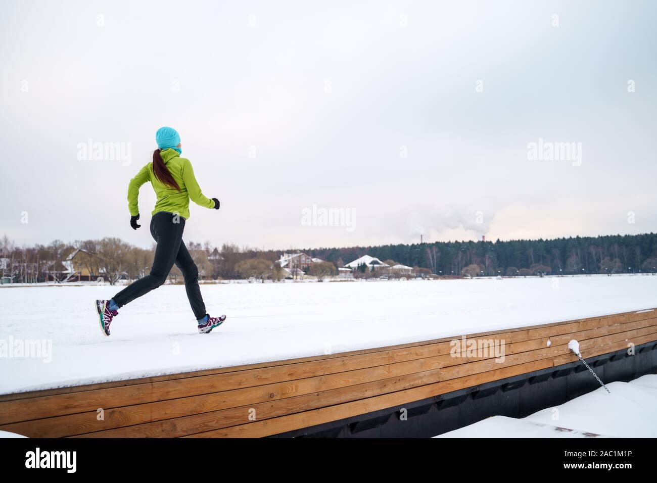 Image of young athlete girl running at winter park in afternoon Stock ...