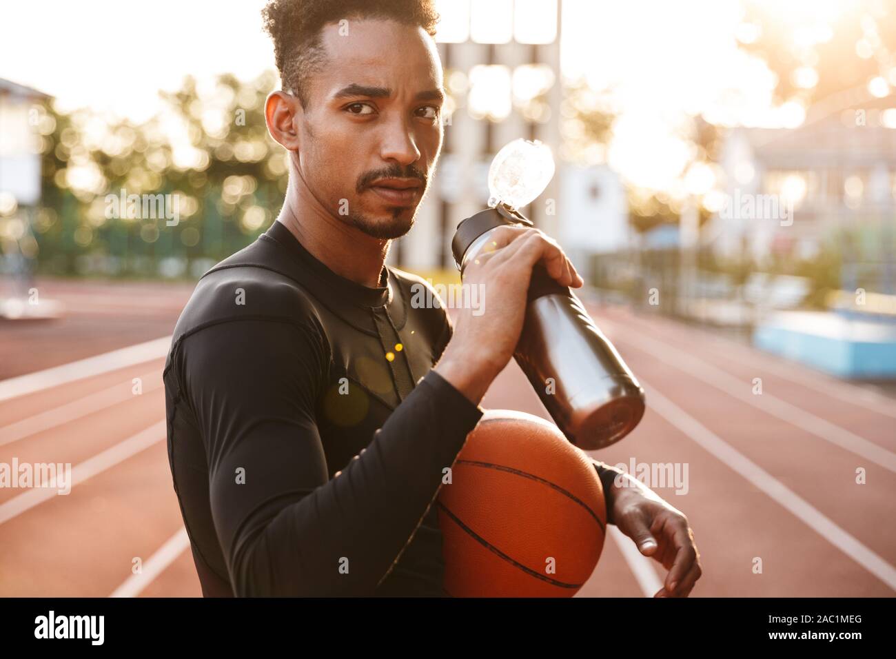 Image of a african handsome young sports man at stadium outdoors ...