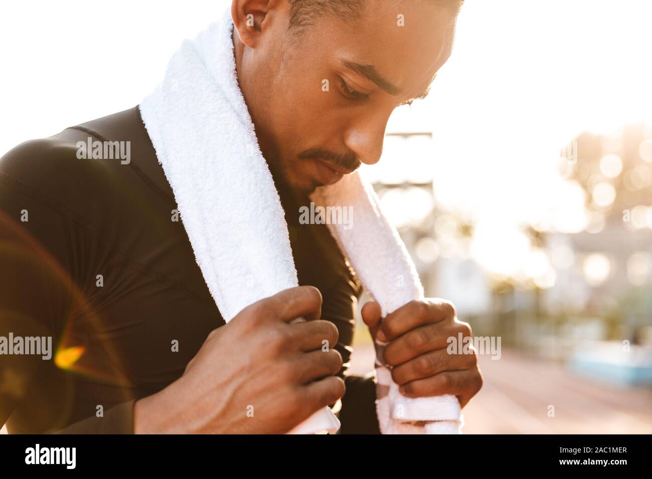 Image of serious african american man standing at running track on ...