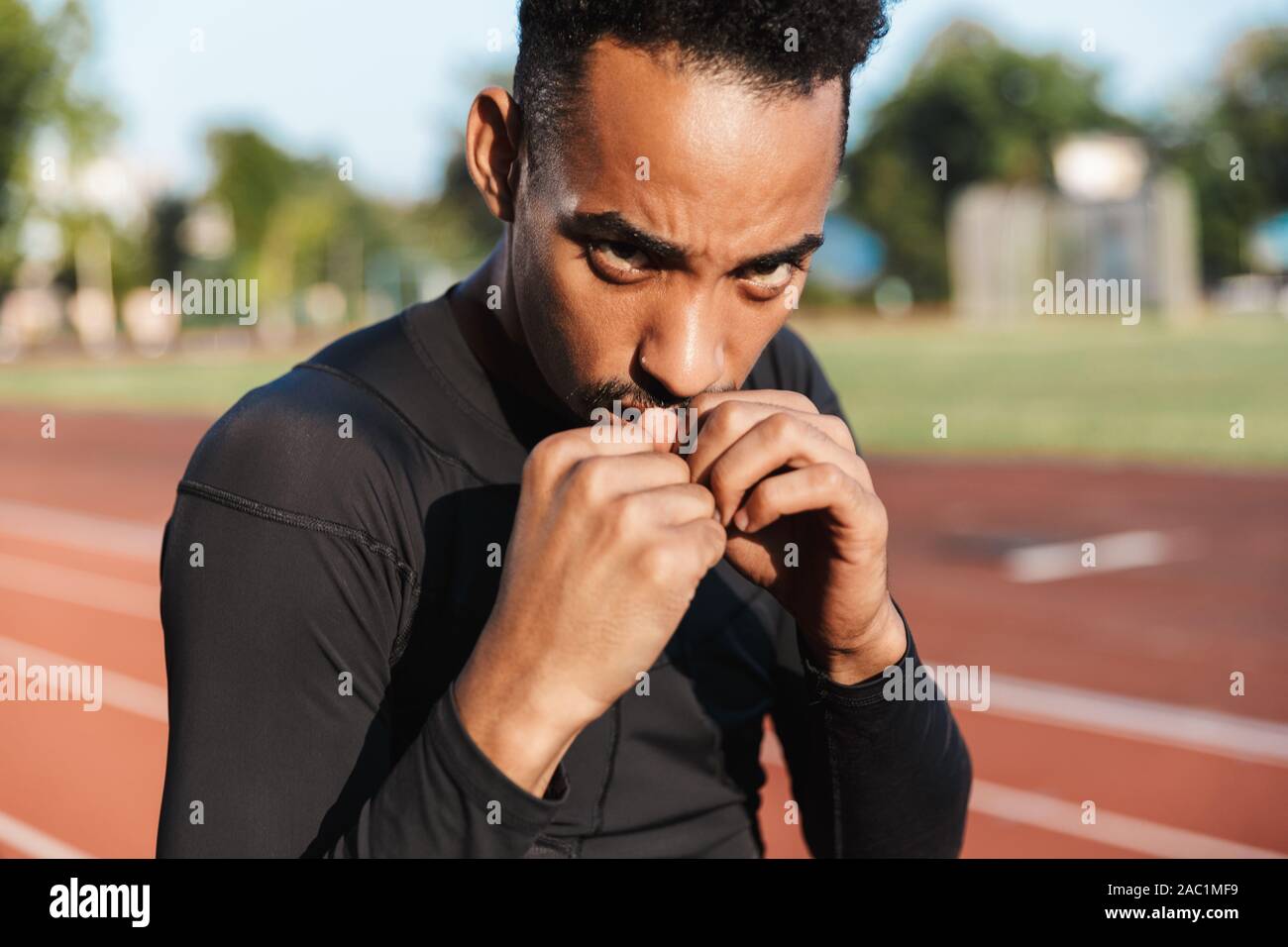 Image of concentrated african american man clenching fists and boxing ...