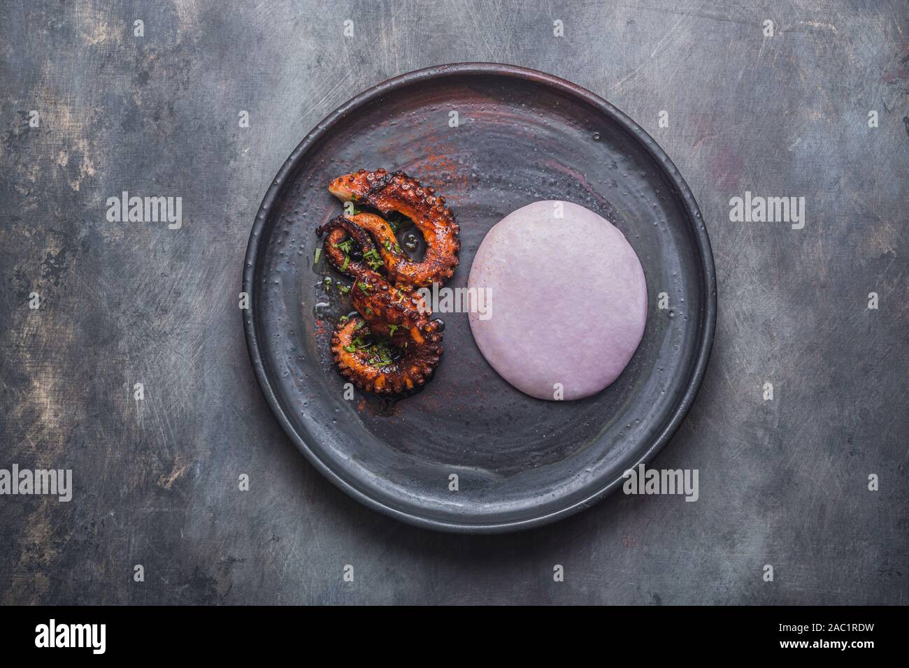 Grilled octopus tentacles with violet potato puree, reastaurant dish ...