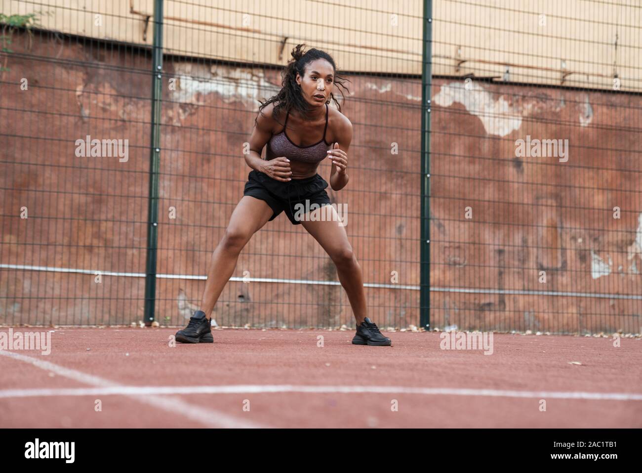 Confident african fitness woman working out at the playground outdoors ...