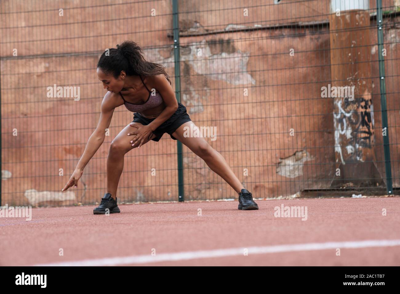 Confident african fitness woman working out at the playground outdoors ...