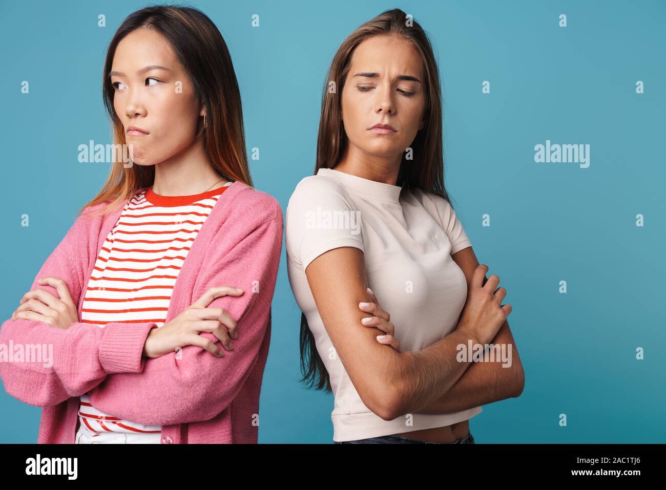 Portrait of multinational displeased women posing with arms crossed ...