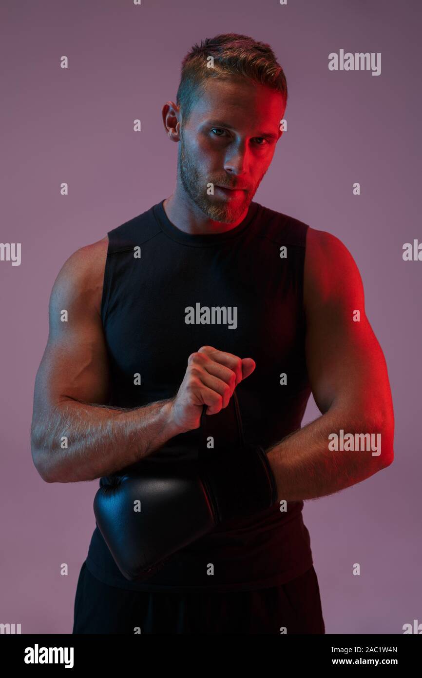 Portrait of a handsome fit muscular boxer man standing isolated over ...