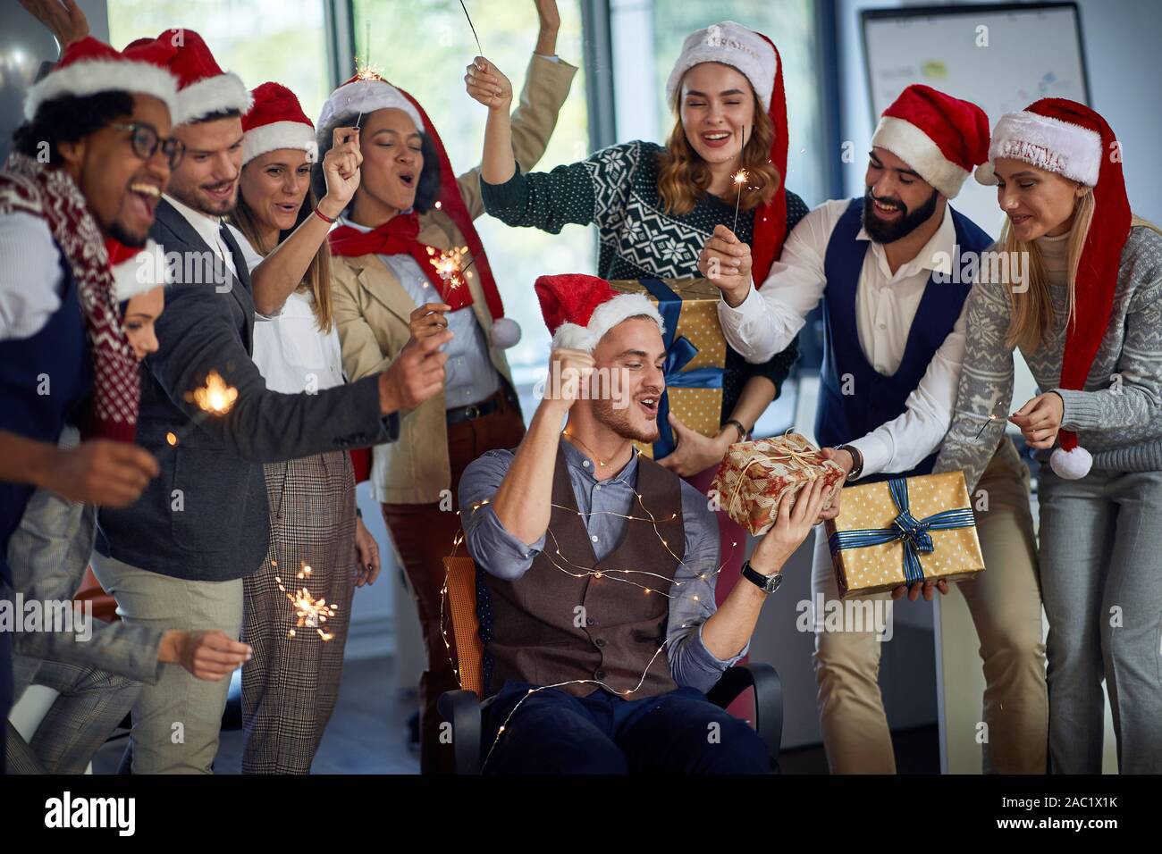 Happy people celebrating Christmas together at work Stock Photo - Alamy