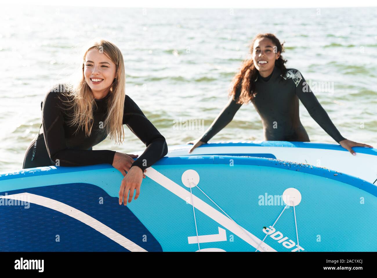 Photo of a beautiful smiling young two women with kayaks outdoors at ...