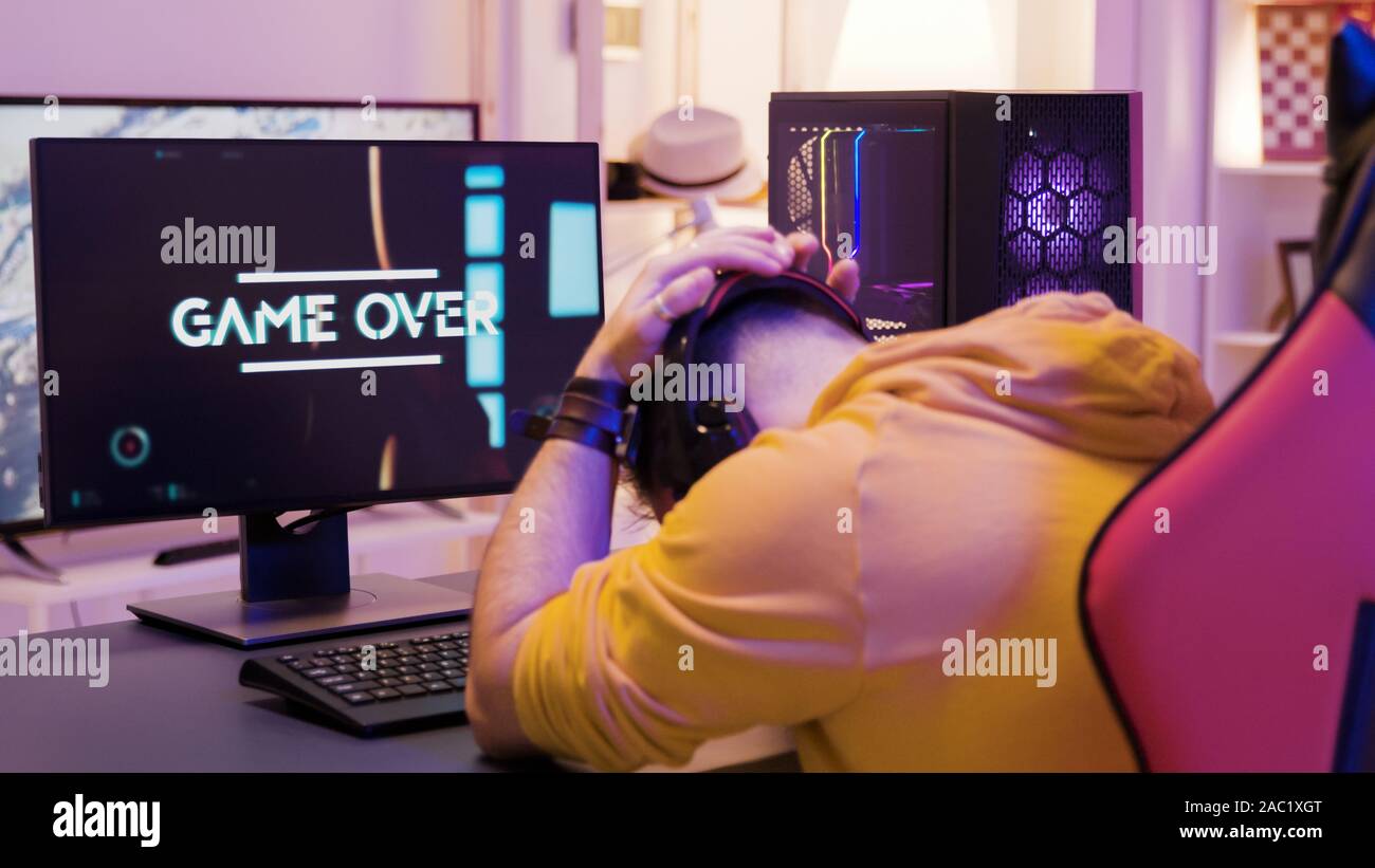 Over the shoulder footage of man playing professional video games in a ...