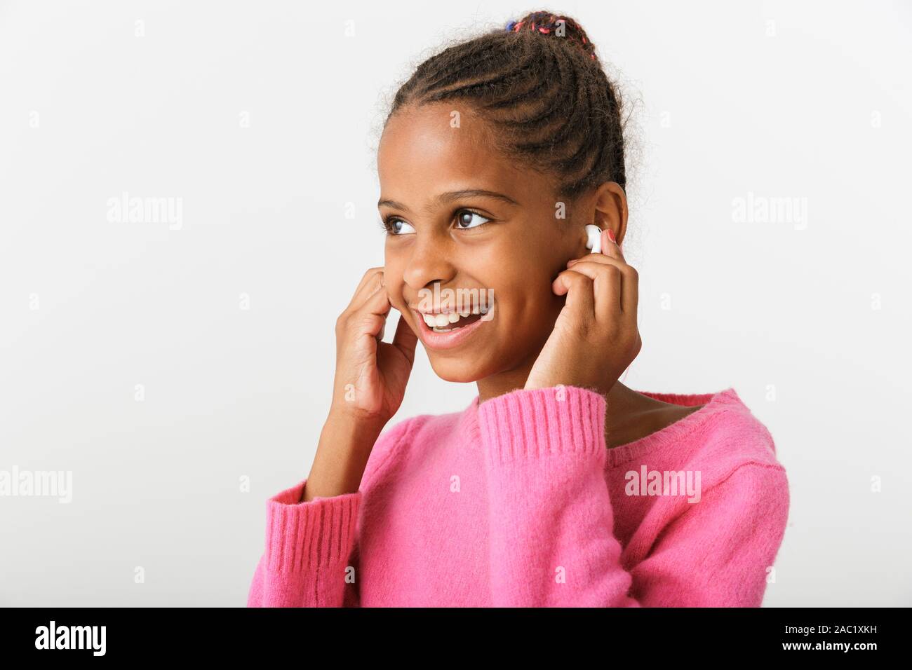Image of nice african american girl listening music with earpods while ...