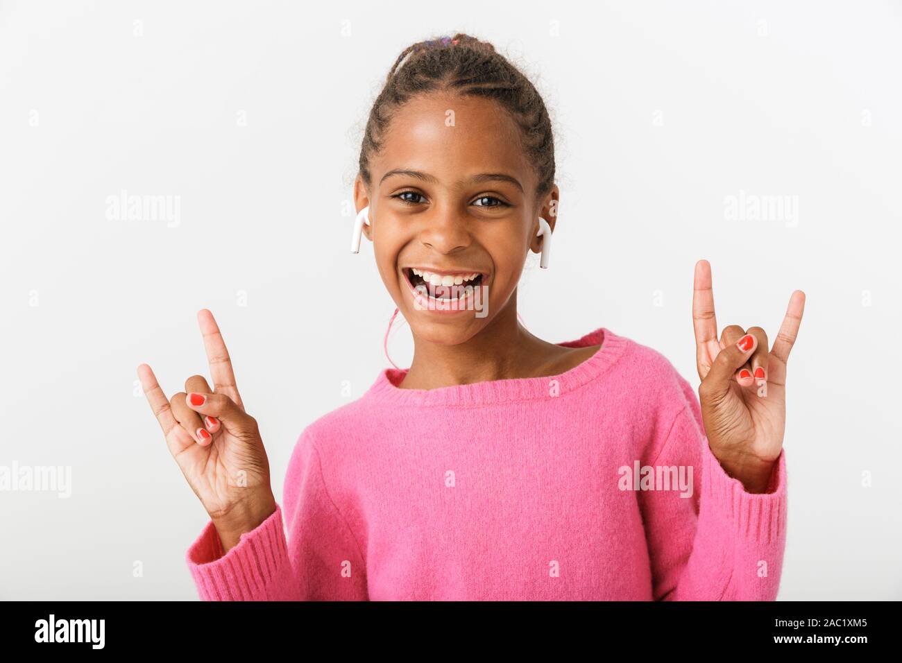 Image of amazed african american girl listening music with earpods ...