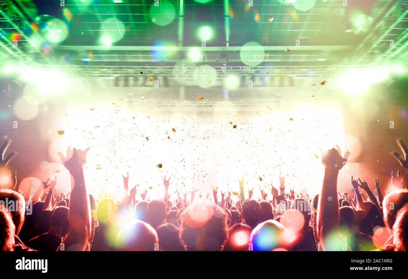 Photo of a concert hall with people silhouettes clapping in front of a ...