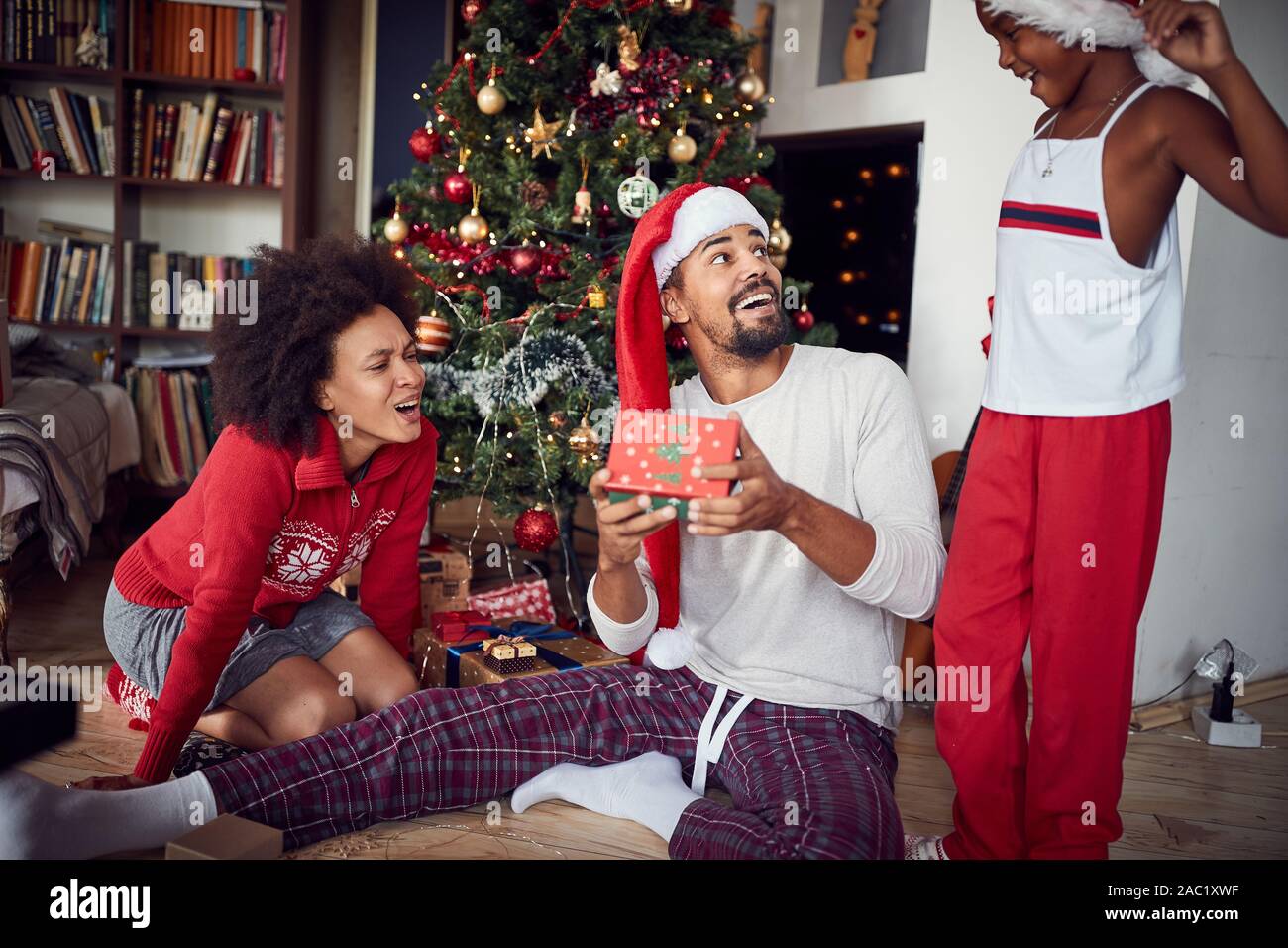 Happy traditional gift opening on Christmas morning Stock Photo - Alamy
