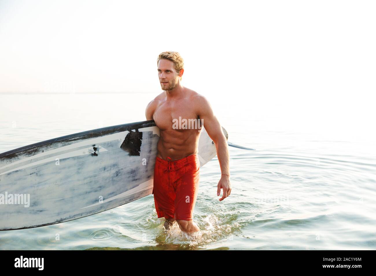 Image of attractive handsome young man surfer with surfing desk at the ...
