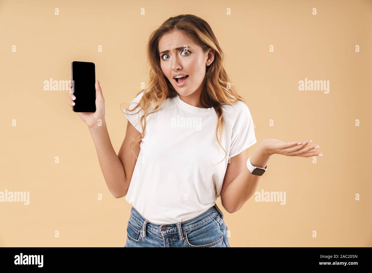 Portrait of excited woman wondering while showing copyspace screen of ...