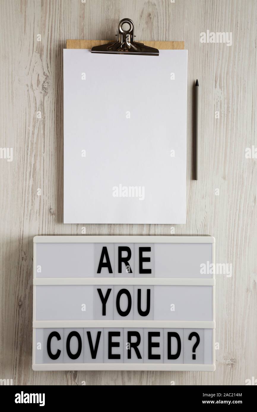 'Are you covered?' words on a modern board, clipboard with blank sheet ...