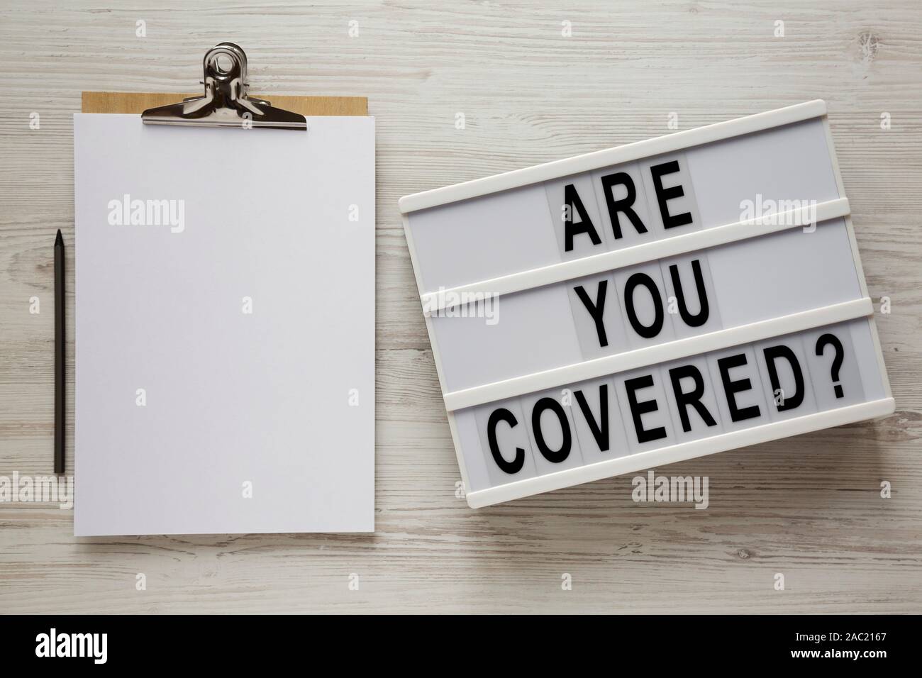 'Are you covered?' words on a modern board, clipboard with blank sheet ...