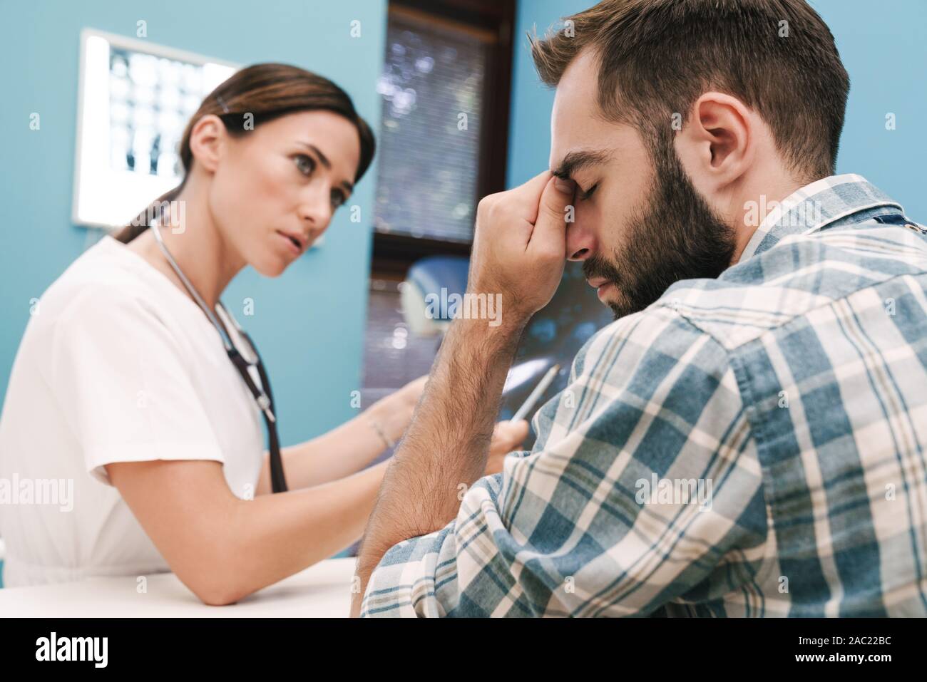Photo of serious woman doctor talking with her stressed sad patient in ...