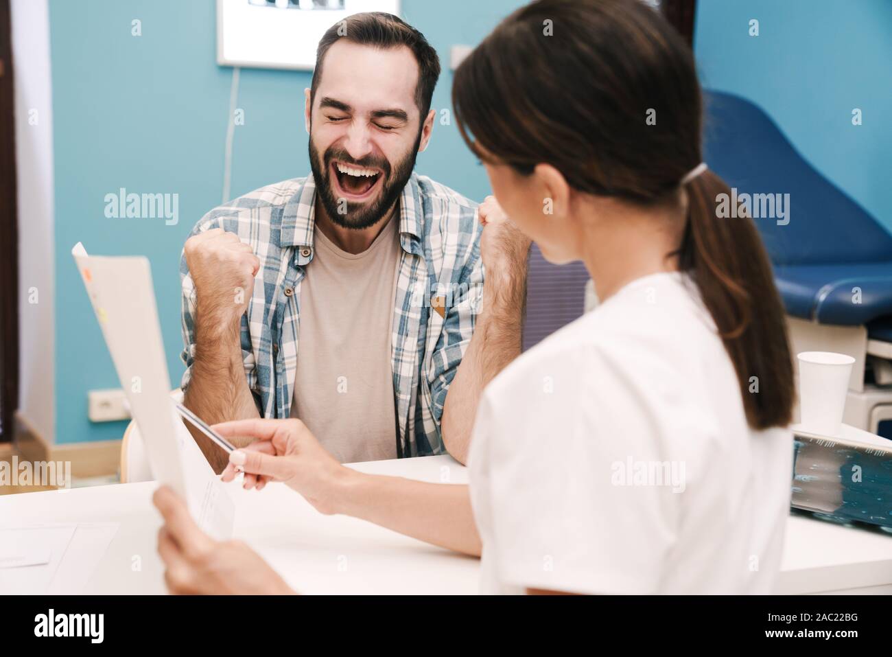 Image of female doctor in medical uniform and joyful patient man ...