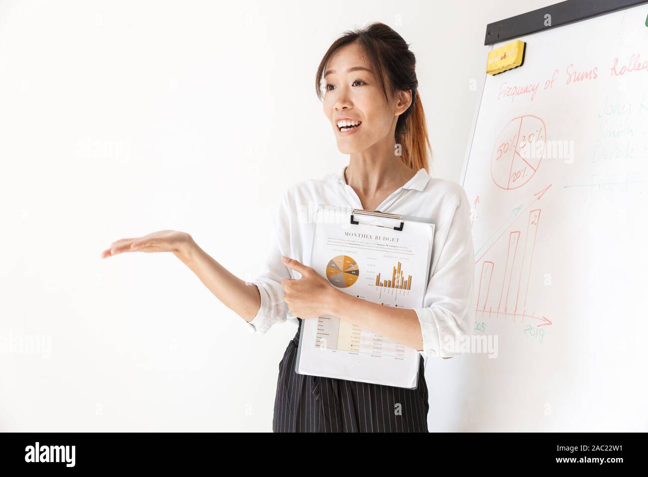 Attractive confident asian businesswoman presenting new project at the ...