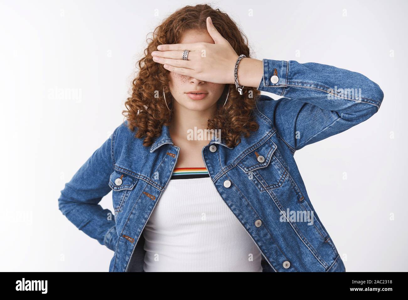 Woman close eyes performing blindness pose hide sight with palm look ...
