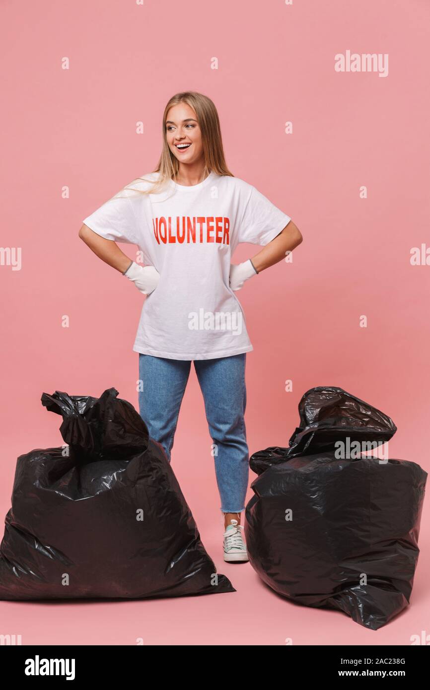 Image of cheerful woman volunteer in uniform t-shirt smiling and ...