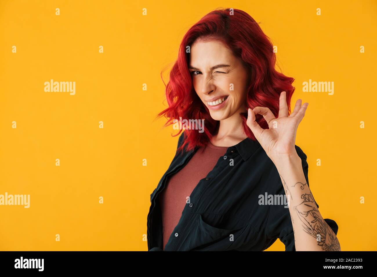 Image of nice smiling woman with curly red hair winking and gesturing ...