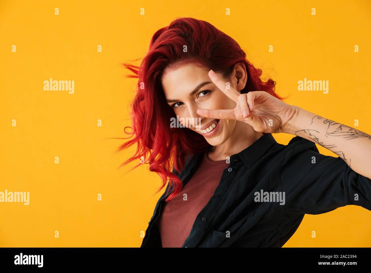 Image of nice joyful woman with curly red hair smiling and gesturing ...