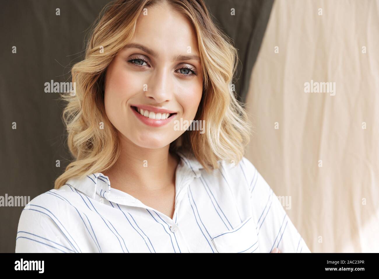 Image of beautiful elegant blonde woman smiling at camera standing ...