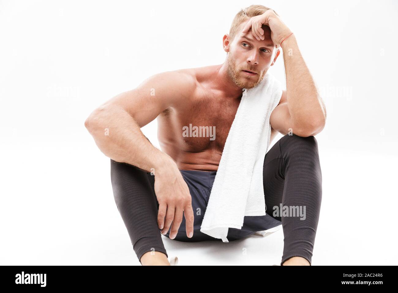 Portrait of a tired fit sportsman resting after work out isolated over ...
