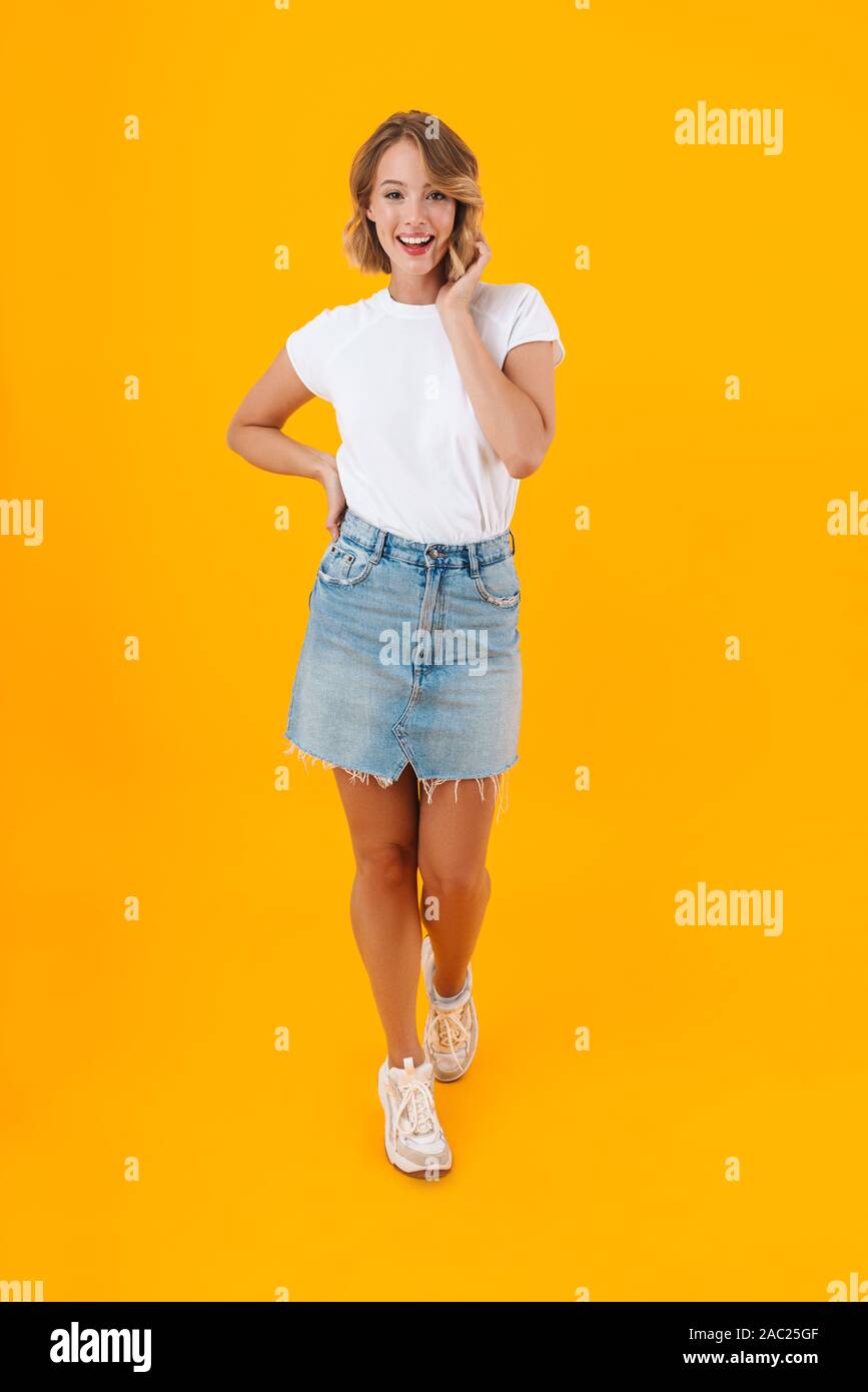 Full length image of attractive woman in basic clothes smiling at ...