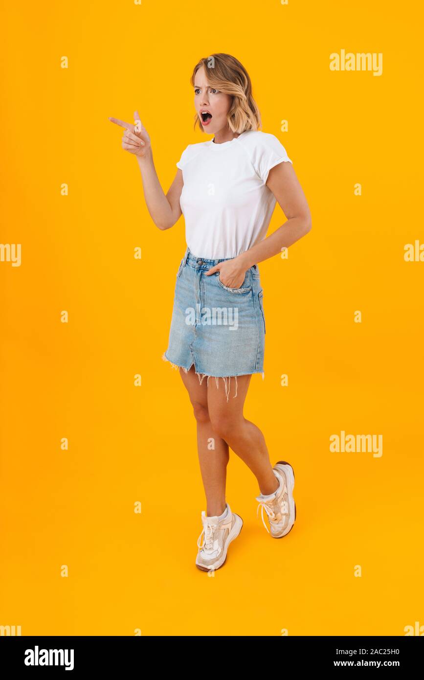 Full length image of outraged woman in basic clothes screaming and ...