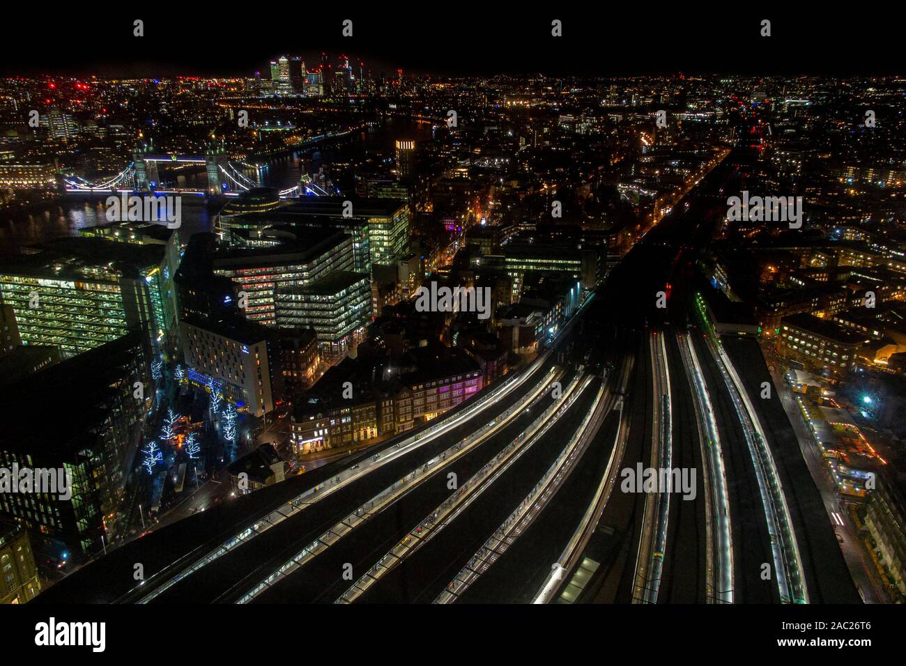 London Bridge train tracks, Tower Bridge and the Docklands at night in ...