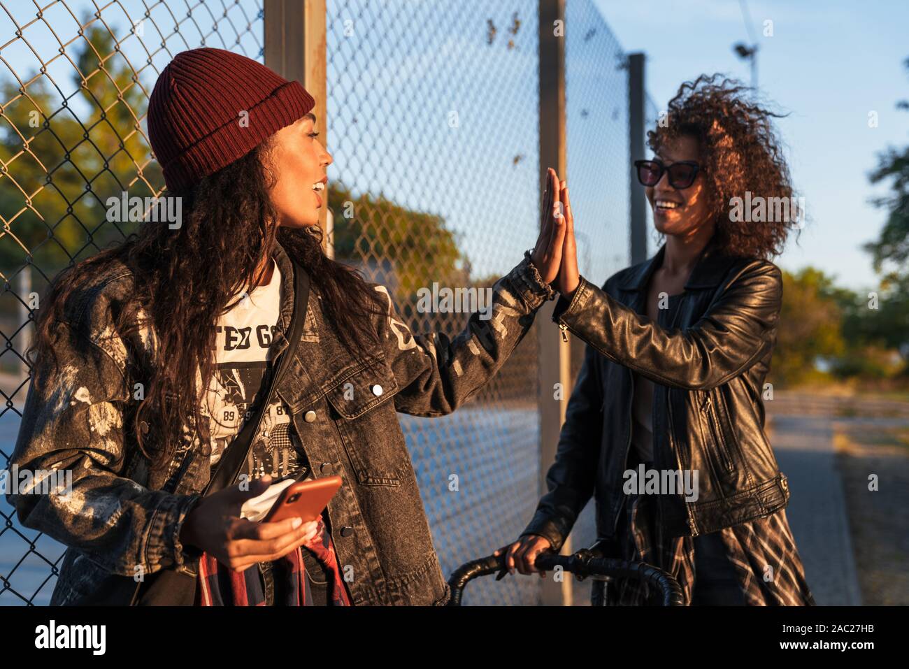 Girls high five outdoors hi-res stock photography and images - Alamy