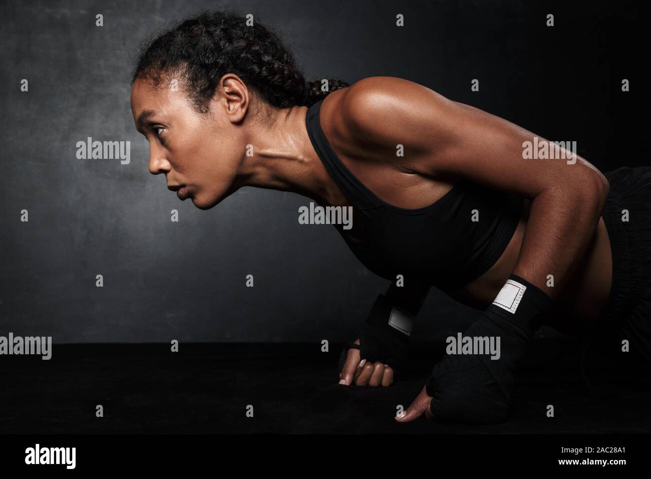 Image of muscular african american woman in sportswear doing push-ups ...
