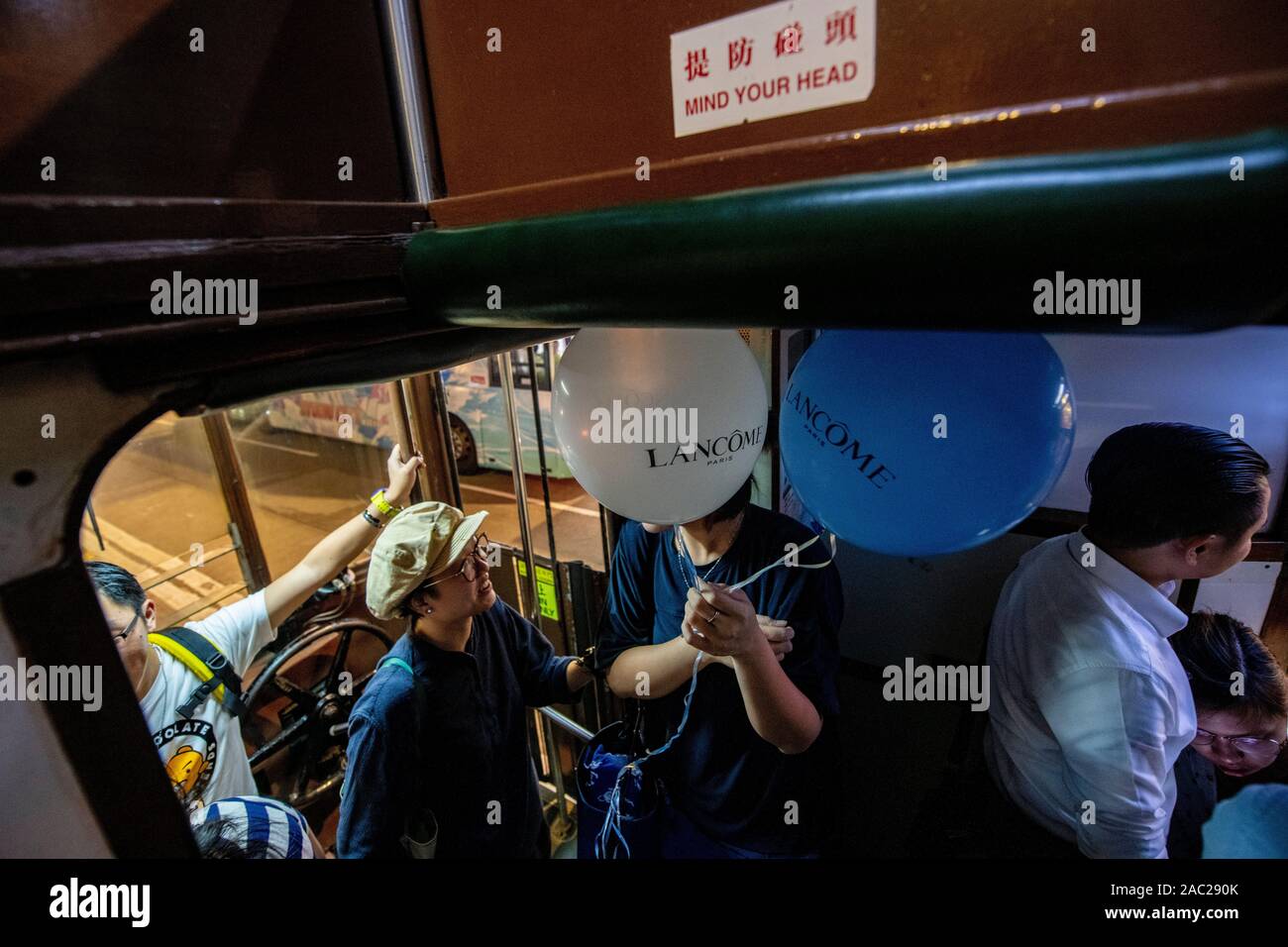 The interior of a crowded tram in rush hour in the centre of Hong Kong ...