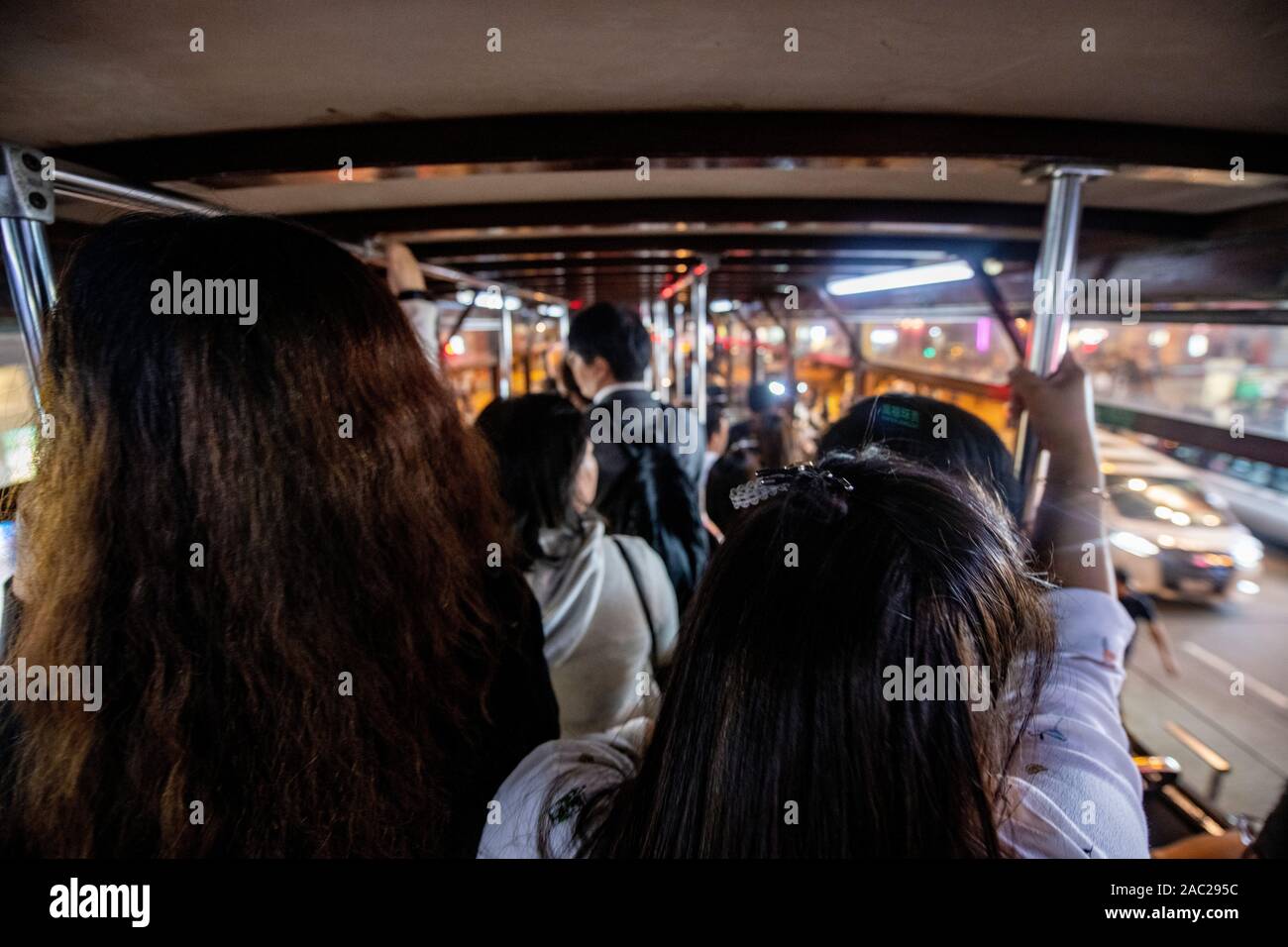 The interior of a crowded tram in rush hour in the centre of Hong Kong ...