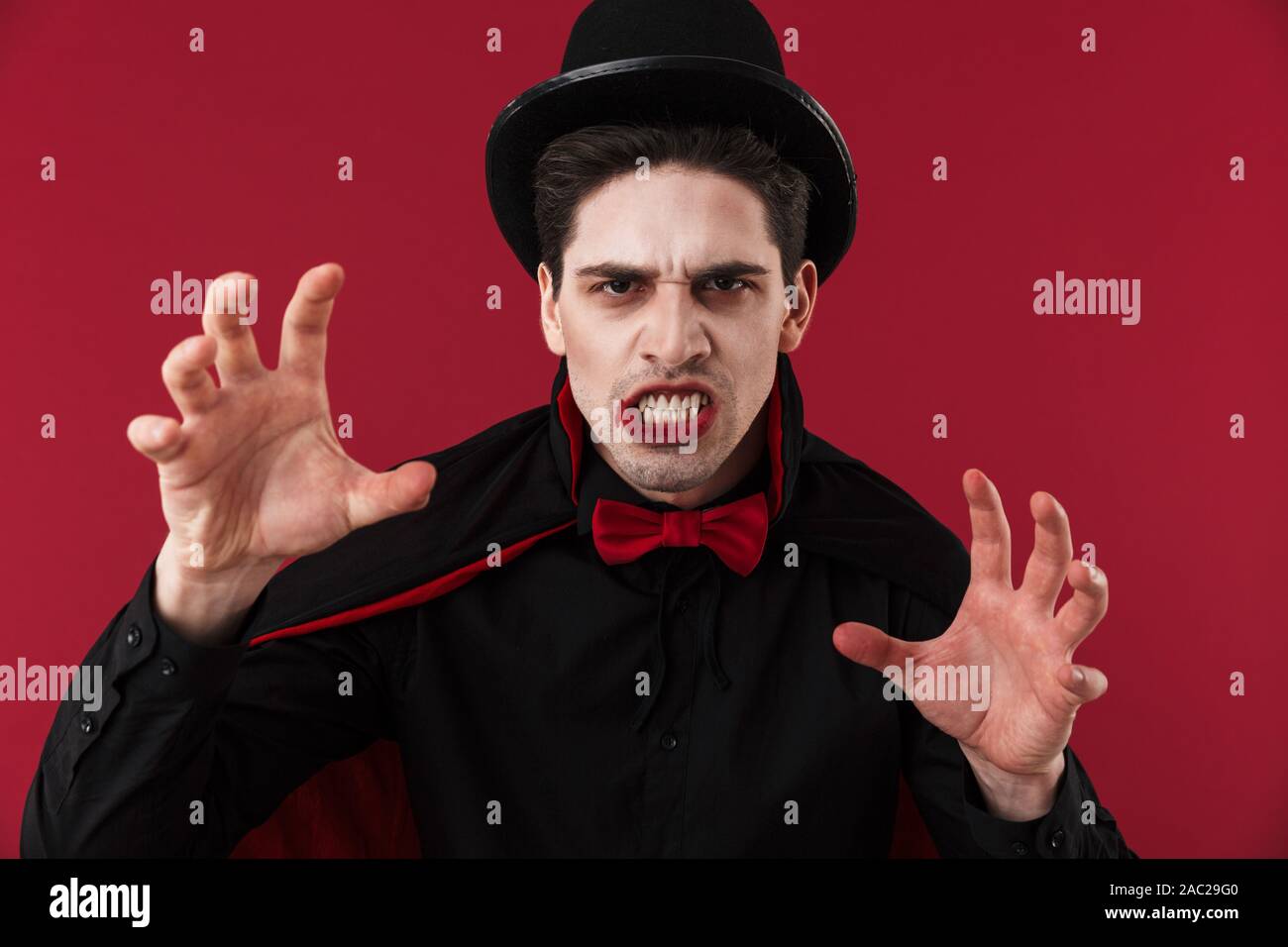 Image of vampire man with blood and fangs in black halloween costume ...