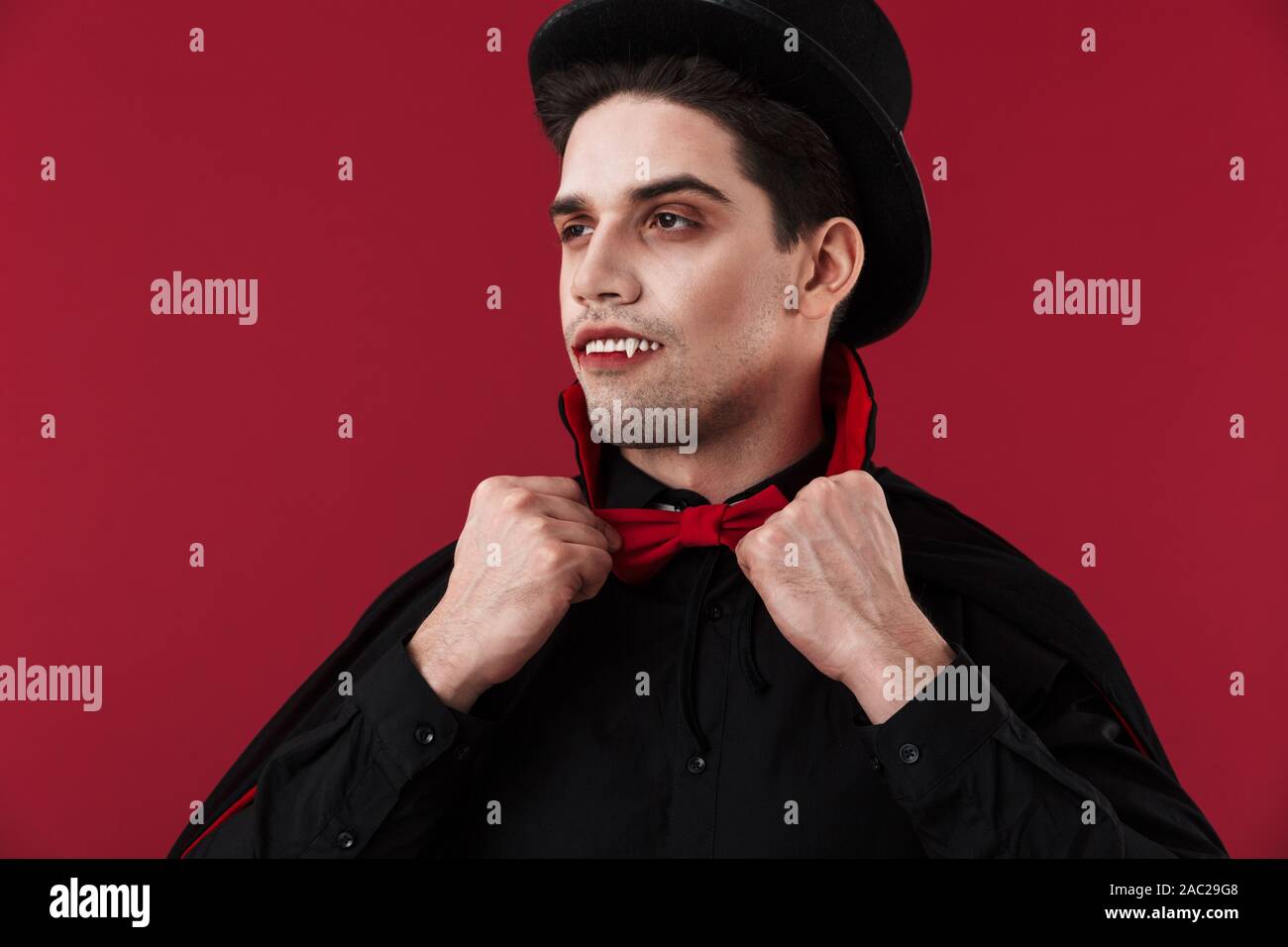 Image of vampire man with blood and fangs in black halloween costume ...