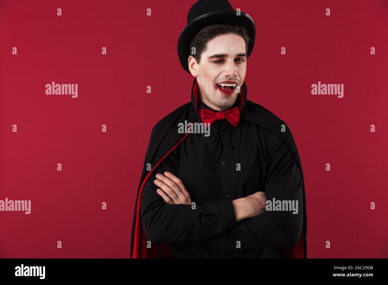 Image of vampire man with blood and fangs in black halloween costume ...