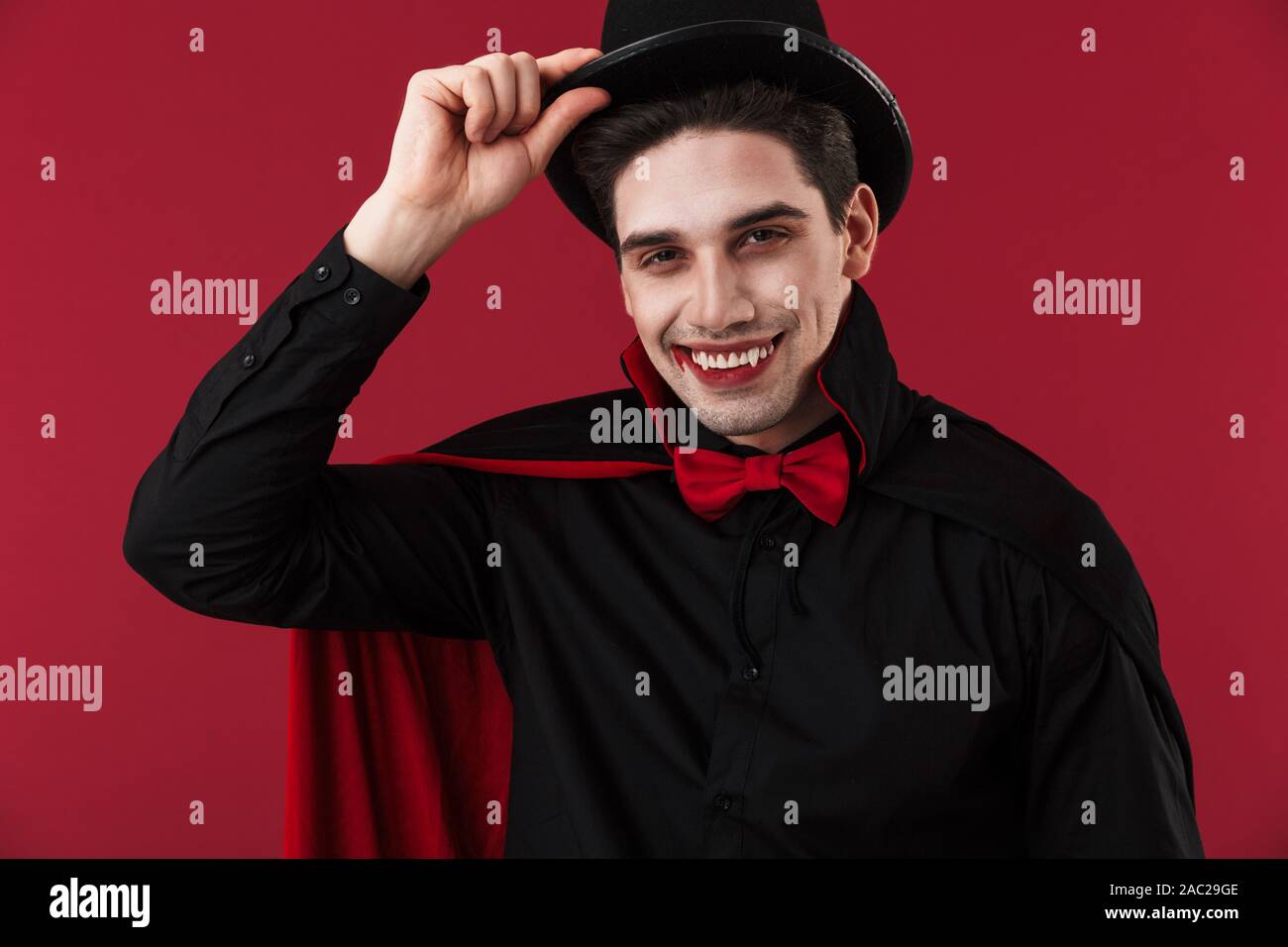 Image of vampire man with blood and fangs in black halloween costume ...