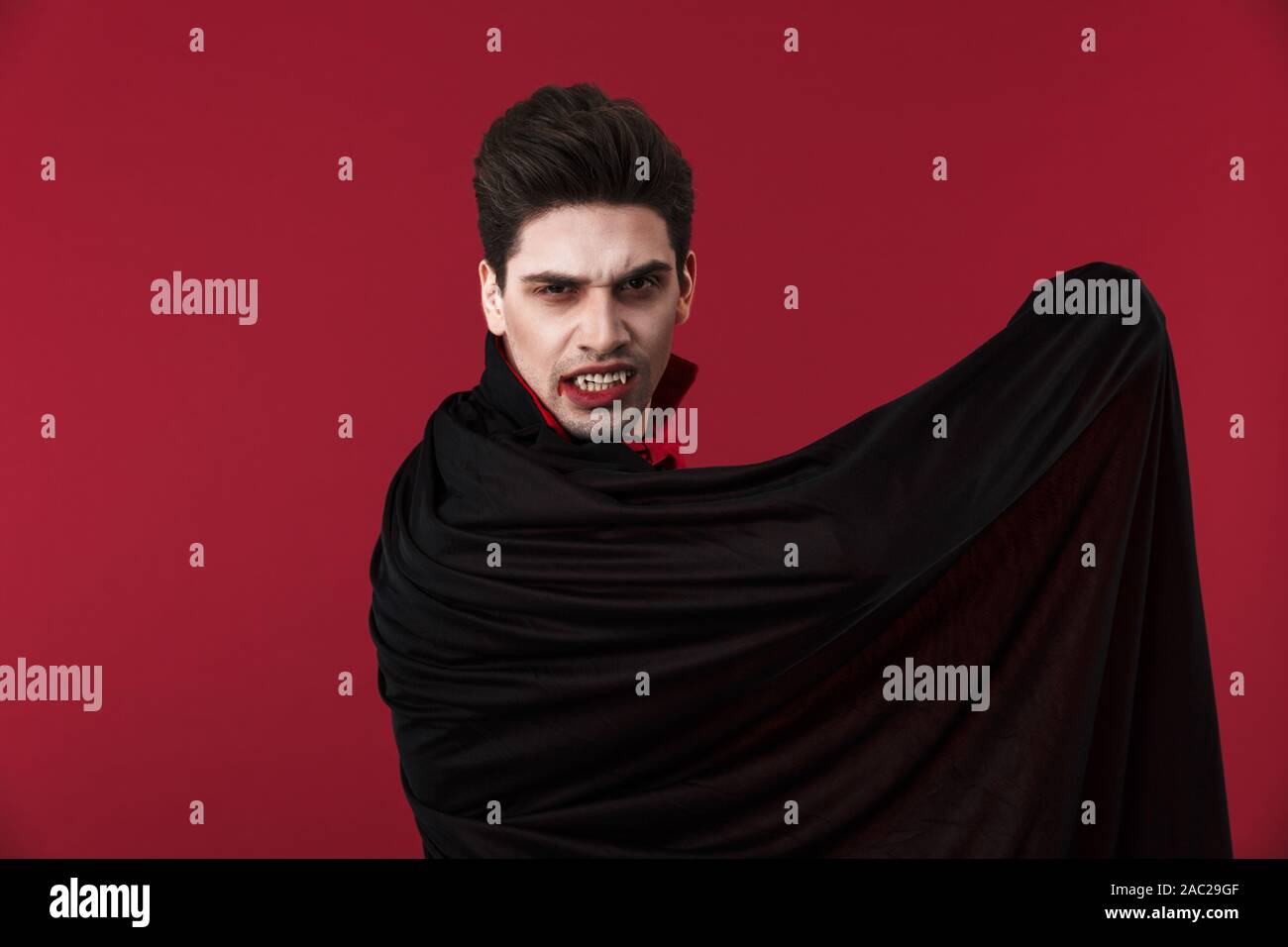 Image of frightening vampire man with blood and fangs in black ...