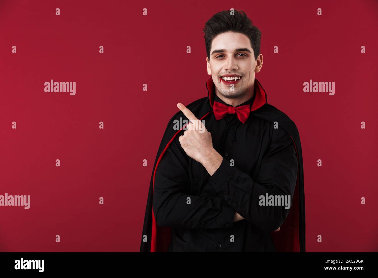 Image of vampire man with blood and fangs in black halloween costume ...