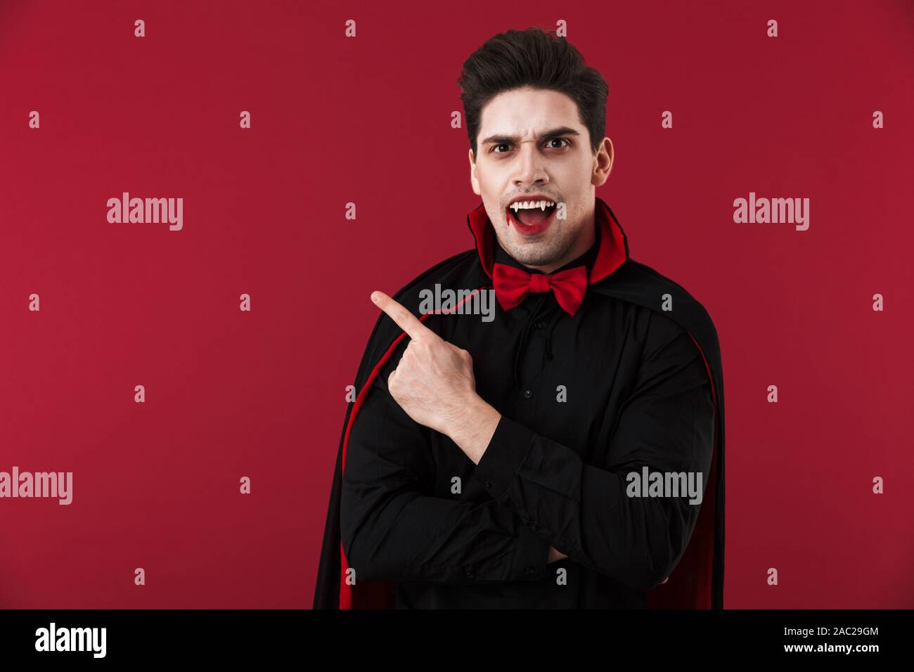 Image of vampire man with blood and fangs in black halloween costume ...
